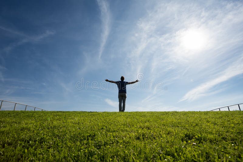 Man Standing on Grass in Sunlight Stock Photo - Image of outdoor ...