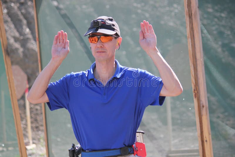Man Standing Hands Up At Gun Range Stock Photo - Image of hands ...