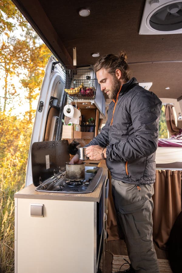 Man Standing in the Kitchen Area of His Camper Van in Autumn Stock ...