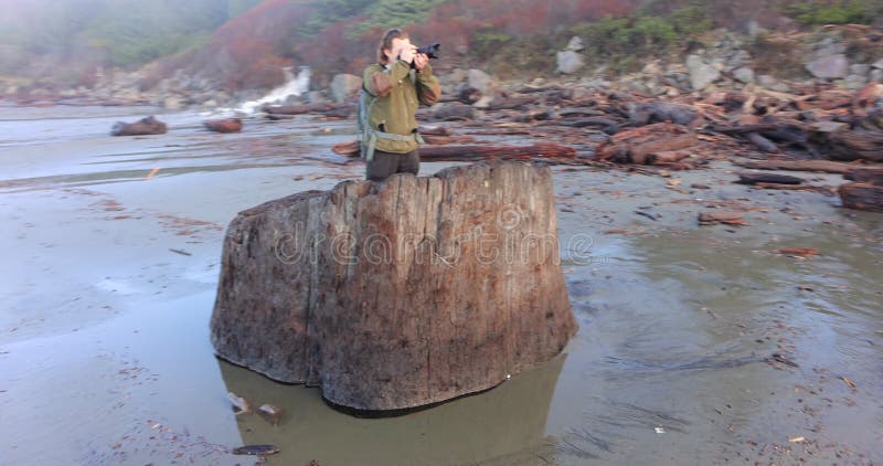 A Man is Standing on a Log in the Ocean Stock Video - Video of camera ...