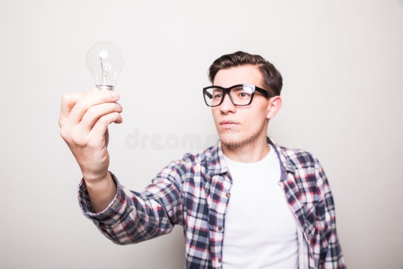 Man Standing and Looking at Light Bulb Stock Image - Image of handsome ...