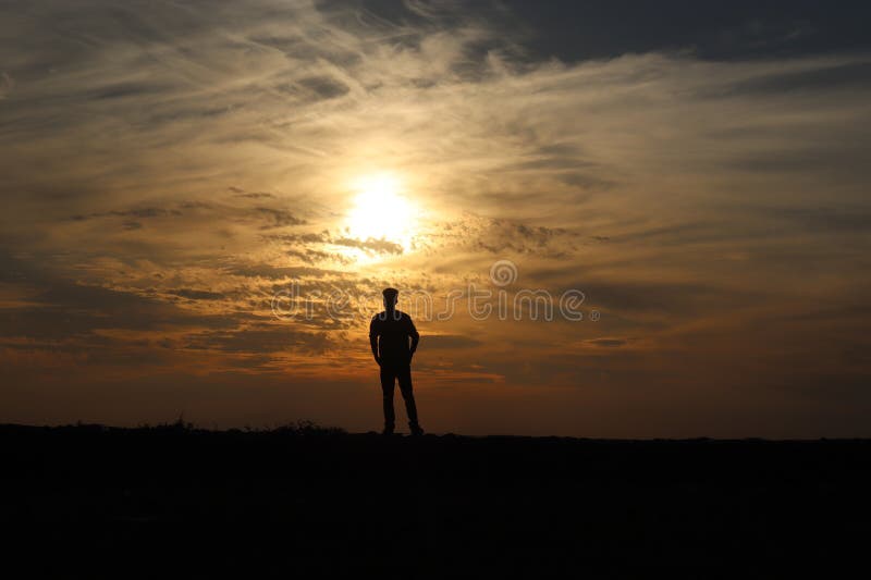 Man Standing and Looking Towards Sunset in Open Sky Stock Photo - Image ...
