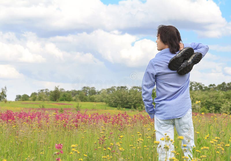 Man Standing on a Meadow with Sneakers Stock Image - Image of green ...