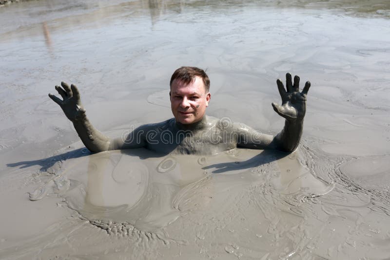 Man standing in mud pool stock image. Image of health - 159958859