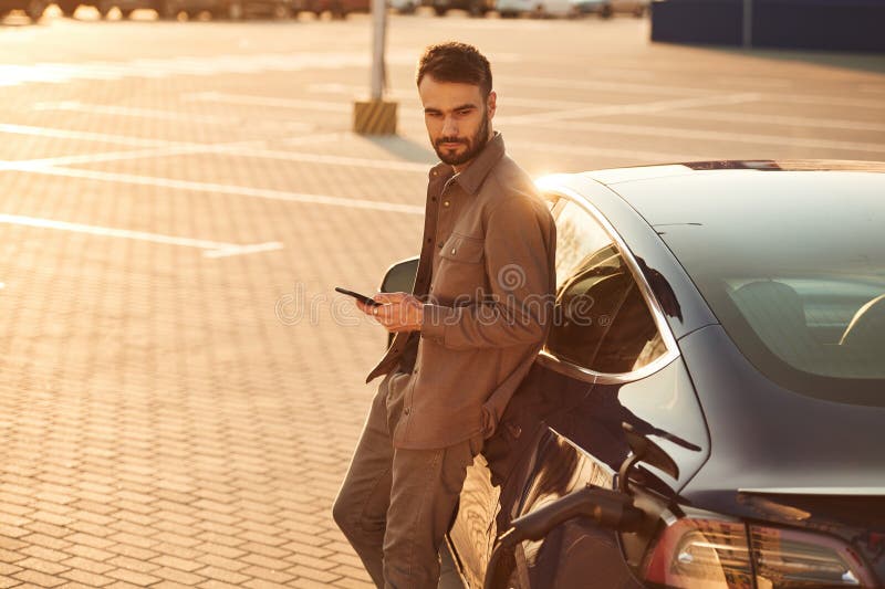 Man is Standing Near His Electric Car Outdoors Stock Image - Image of ...