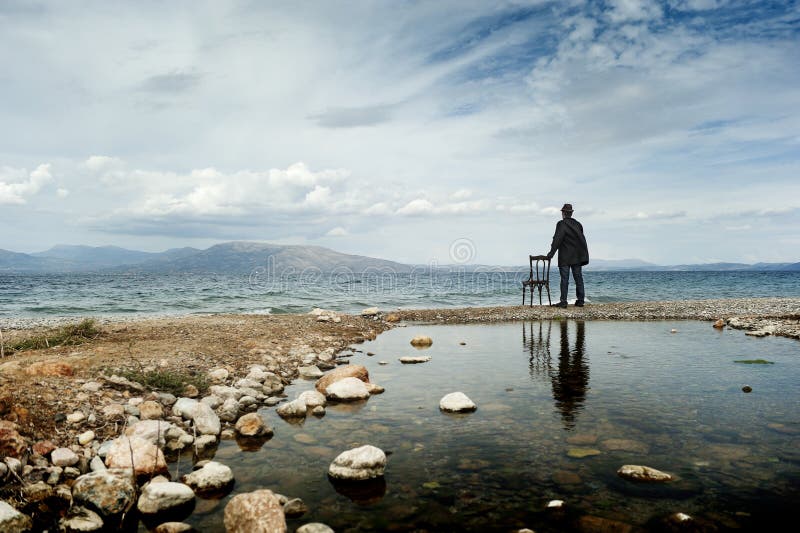 Man Standing Next To a Chair Outdoors Stock Photo - Image of nature ...