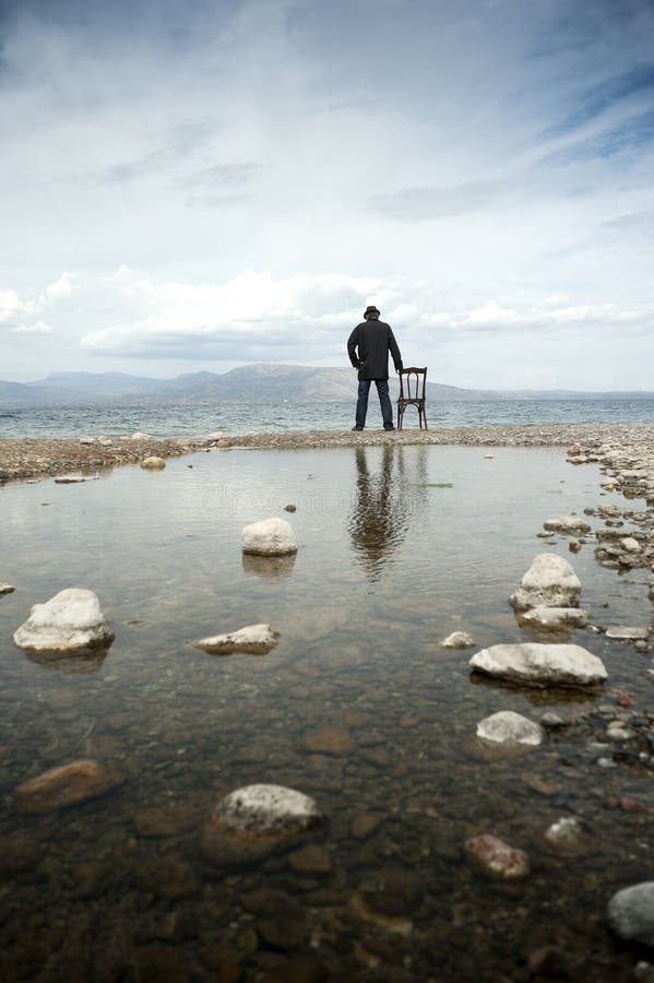 Man Standing Next To A Chair Outdoors Stock Image - Image of horizon ...
