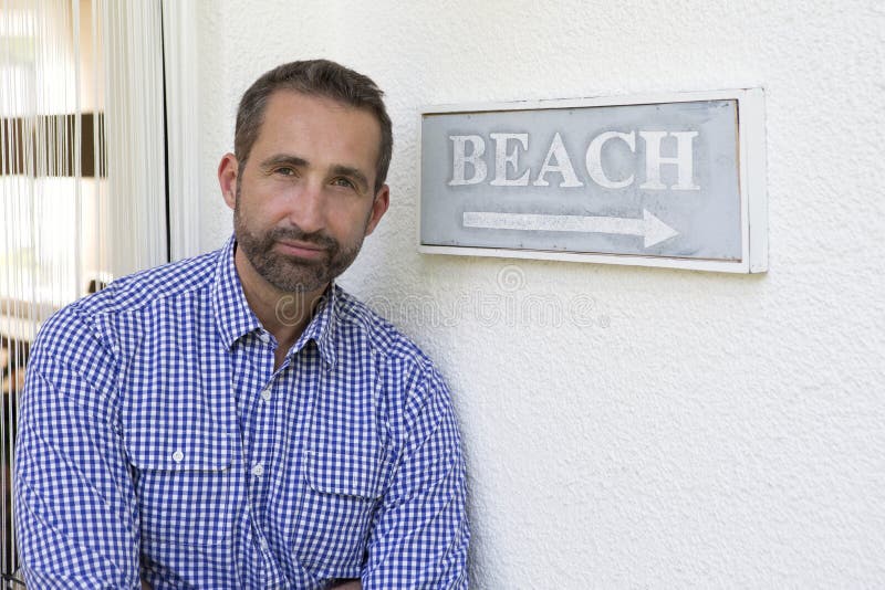 Man Standing Next To a Sign Stock Photo - Image of sign, beach: 55366788