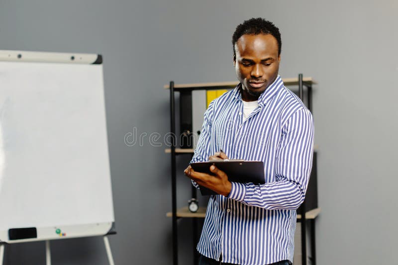 Man Standing in Office Looking at Tablet Stock Photo - Image of ...