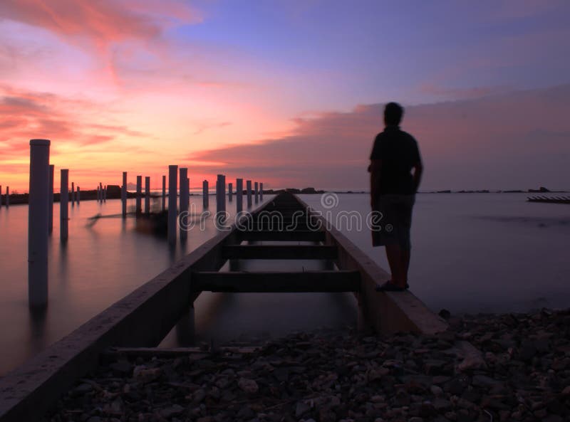 Man Standing On The Pier And Looking Into The Distance Of The Ocean ...