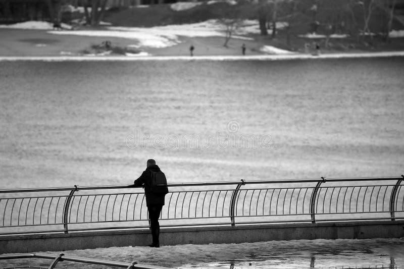 A Man Standing at the Railing at the Dnipro River from Back in Black ...