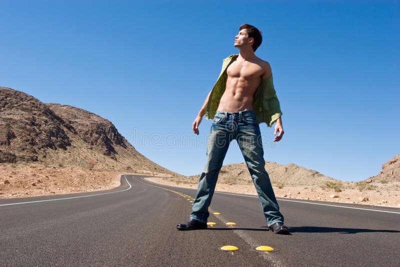 Man standing on the road stock image. Image of jeans, young - 8344059