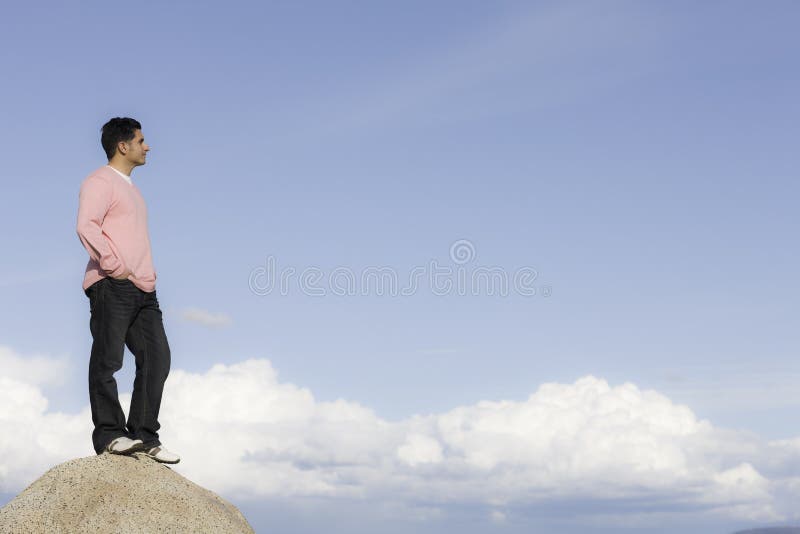 Man Standing on Rock Looking into Distance Stock Photo - Image of ...
