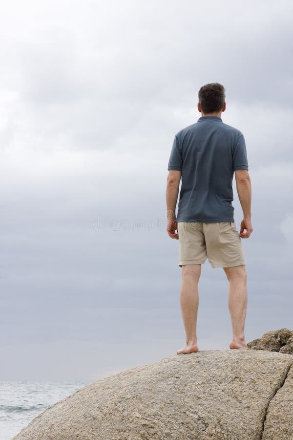 Man Standing on a Rock at the Sea Stock Photo - Image of vacations ...