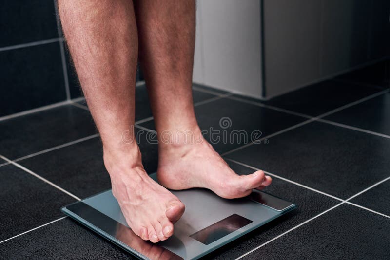 Standing on a scale stock image. Image of black, examining - 17968639