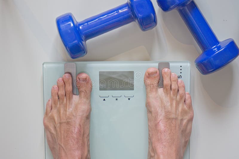 Man standing on scale stock photo. Image of measure - 144093946