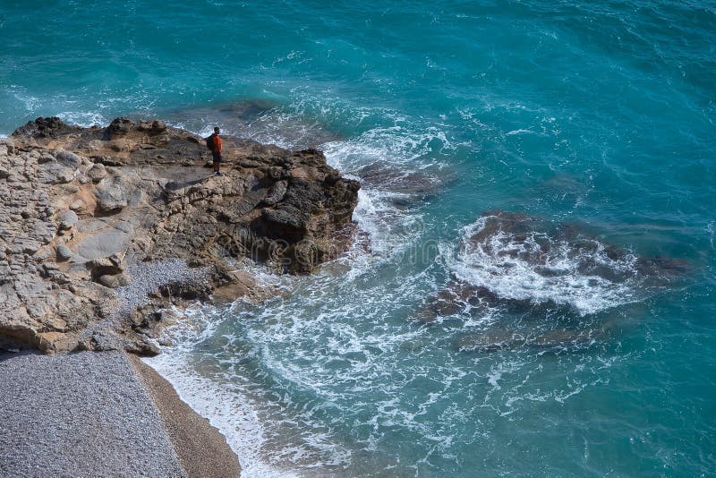 Man Standing on the Sea Shore Facing the Waves Stock Photo - Image of ...
