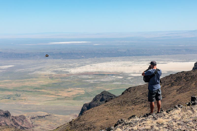 A Man Taking Pictures of Alvord Desert from Steens Mountain Summit ...