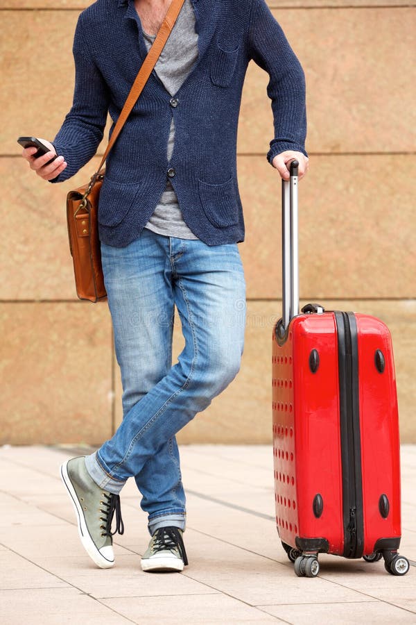 Man Standing on Sidewalk with Mobile Phone and Suitcase Stock Image ...