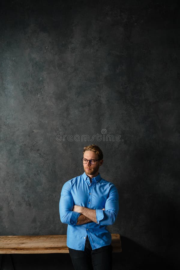 The Man in Standing while Sitting Down at the Table in the Studio Stock ...