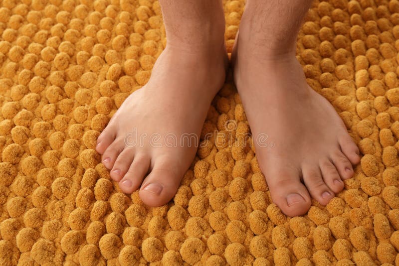 Man Standing on Soft Orange Bath Mat, Closeup Stock Photo - Image of ...