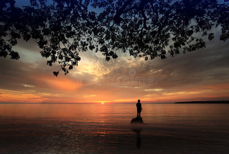 Man standing at a sunset stock photo. Image of horizon - 27344202