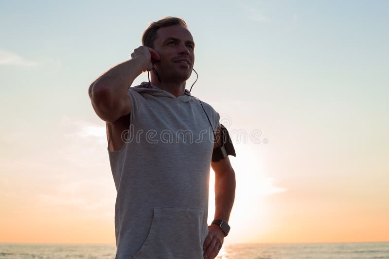 Man Standing in Sunset after Workout Stock Image - Image of listen ...