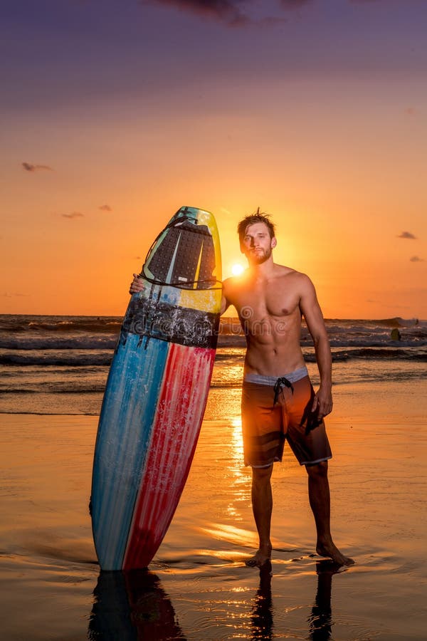 Surfer on the beach stock photo. Image of outdoors, dawn - 114177504