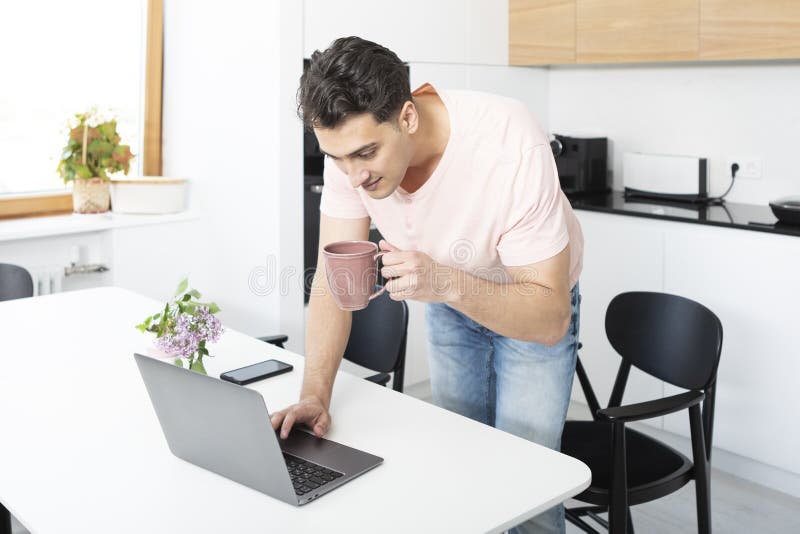 Man Standing at the Table and Working on Laptop Stock Image - Image of ...