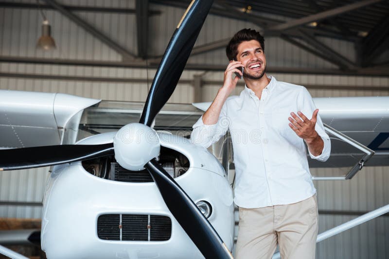 Man Standing and Talking on Mobile Phone Near the Plane Stock Image ...