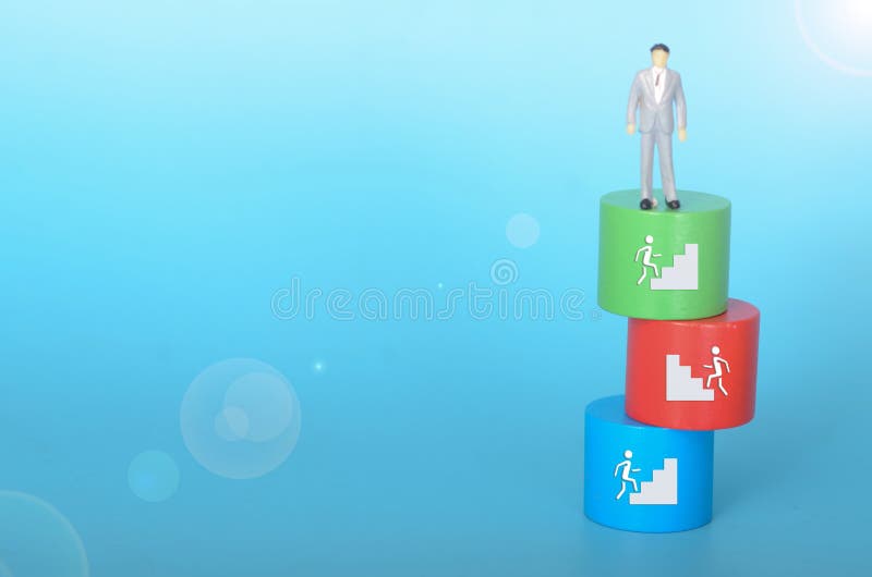 A Man Standing on Top of a Stack of Colorful Blocks, Symbolizing ...