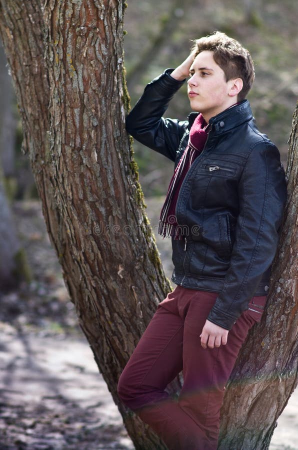 Man Standing at Tree Outdoor Stock Image - Image of goodlooking, color ...