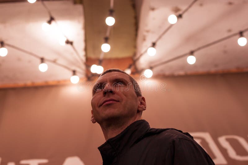Man Standing Under Lighting Lamps and Looking Up Stock Photo - Image of ...