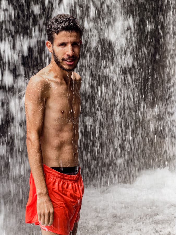 Man Standing Under a Waterfall Stock Image - Image of enjoy, adventure ...