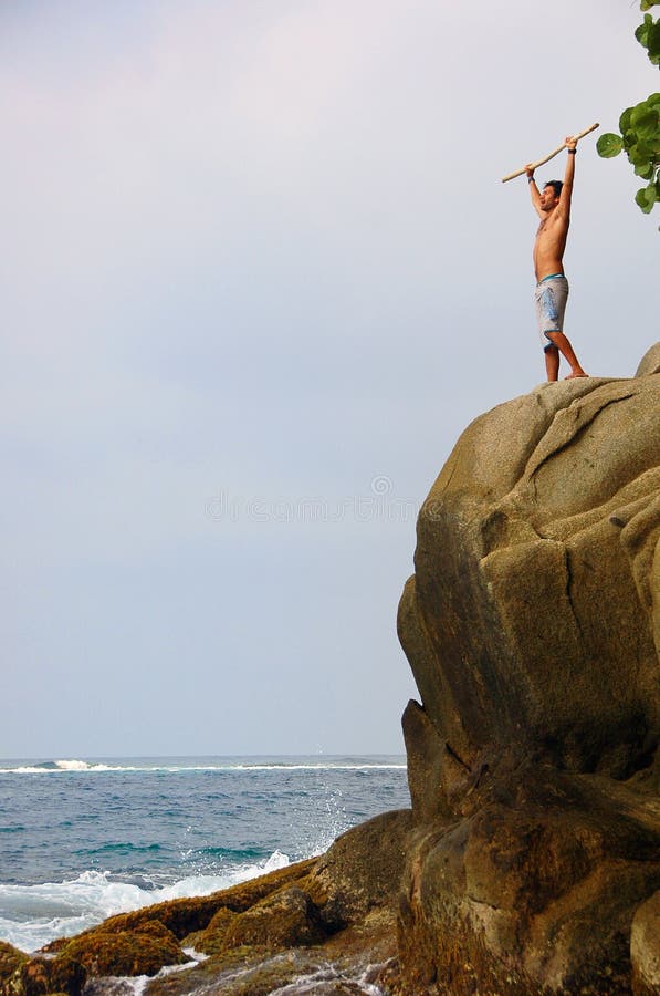 Man Standing Victoriously on a Cliff Stock Image - Image of freedom ...