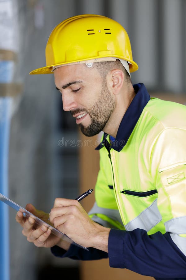 Man Standing and Writing in Folder Stock Photo - Image of document ...