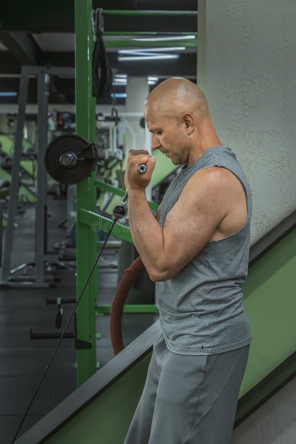 Man Stands in a Crossover Simulator and Performs an Exercise for ...