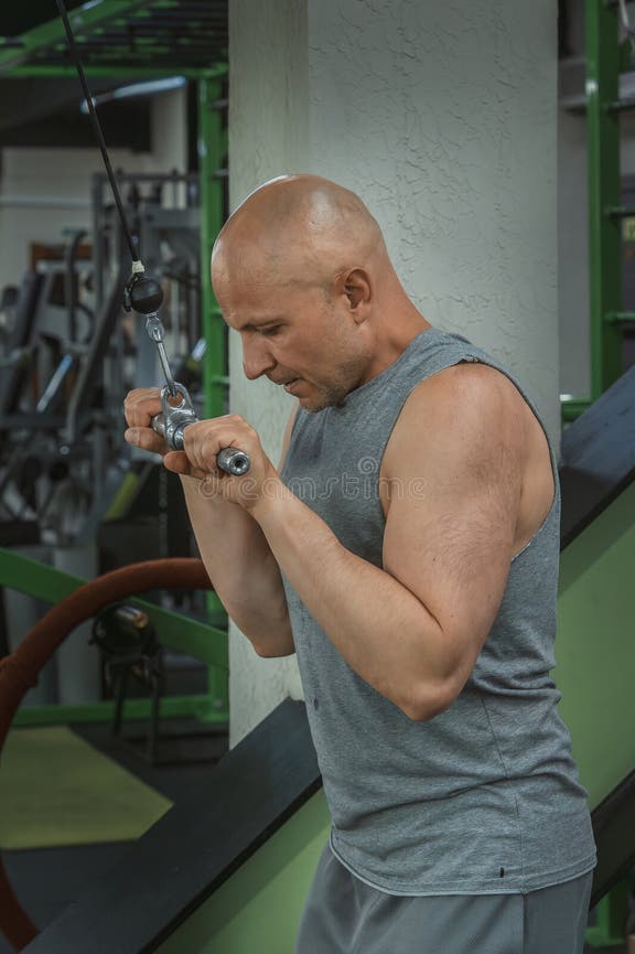 Man Stands in a Crossover Simulator and Performs an Exercise for ...