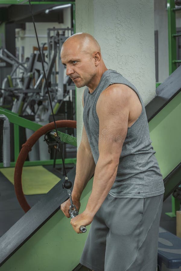 Man Stands in a Crossover Simulator and Performs an Exercise for ...