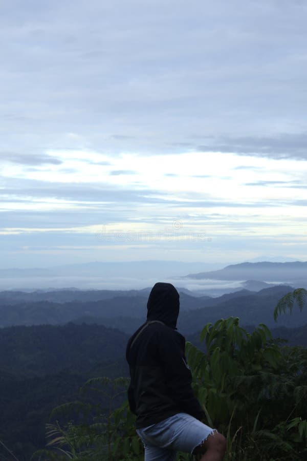 A Man Stands on a Mountain Overlooking a Valley Stock Image - Image of ...