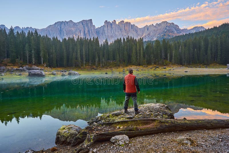 Man Stands on a Stone by the Lake, Watching the Sunrise Over the ...