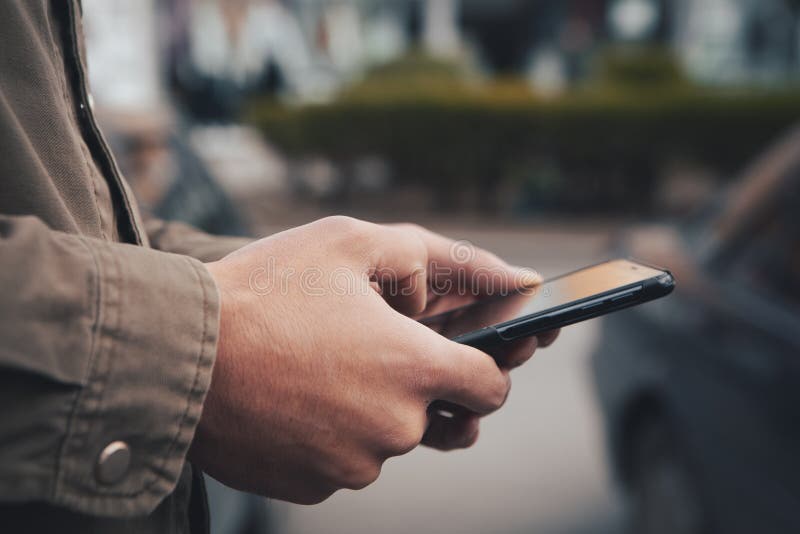 A Man Stands on the Street and Uses the Phone Stock Image - Image of ...