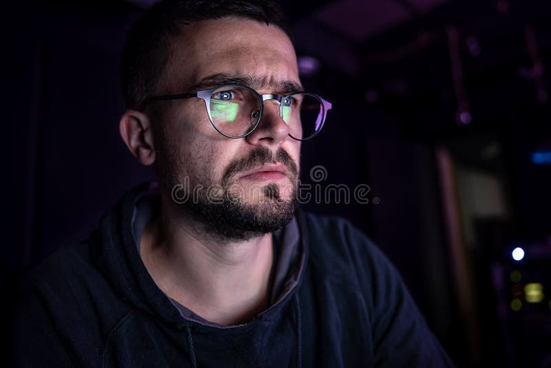 A Man Stares Intently at a Computer Screen in the Dark at Night Stock ...