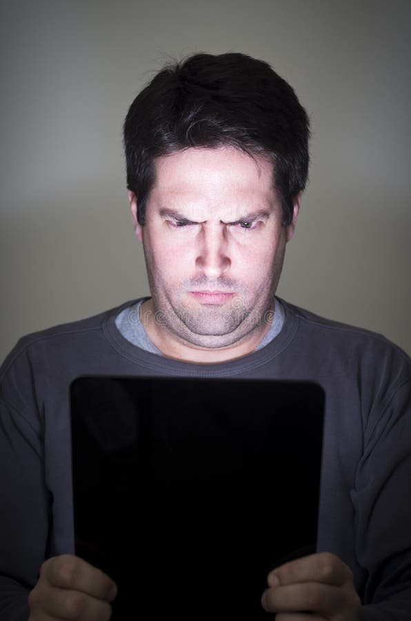 Man Stares Intently at a Tablet Device Stock Photo - Image of ...