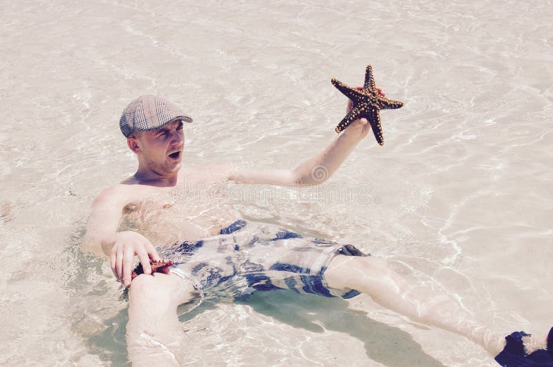 Man and starfish stock image. Image of ocean, starfish - 94757331