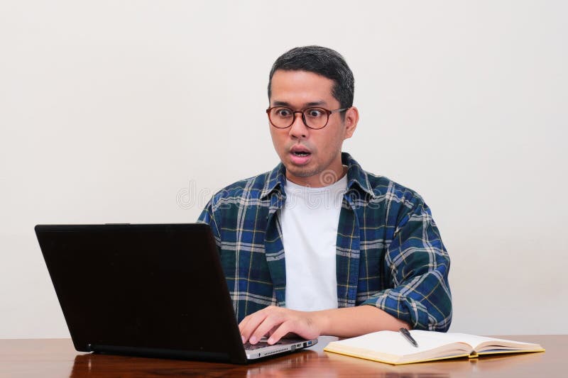 A Man Staring His Laptop with Shocked Expression Stock Photo - Image of ...