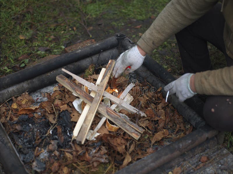 Man starting a bonfire stock photo. Image of fire, bonfire - 200195876