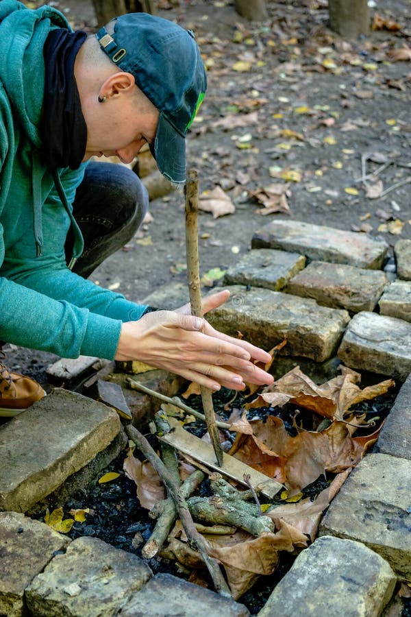 Man Starting a Fire for the Barbeque in the Woods. Stock Image - Image ...