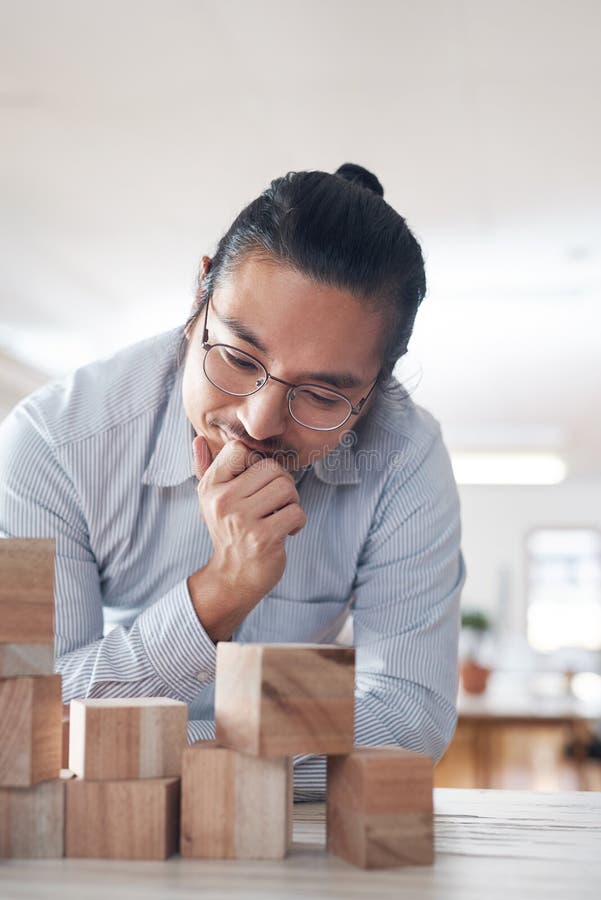Man in Startup with Building Blocks, Thinking of Vision, Games and ...