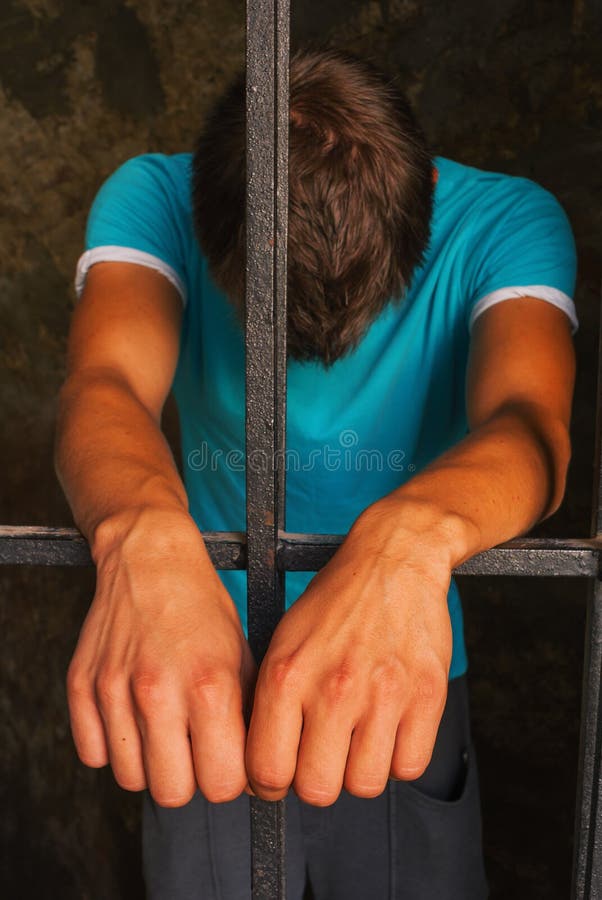 Man behind the bars stock photo. Image of hands, dark - 21557058